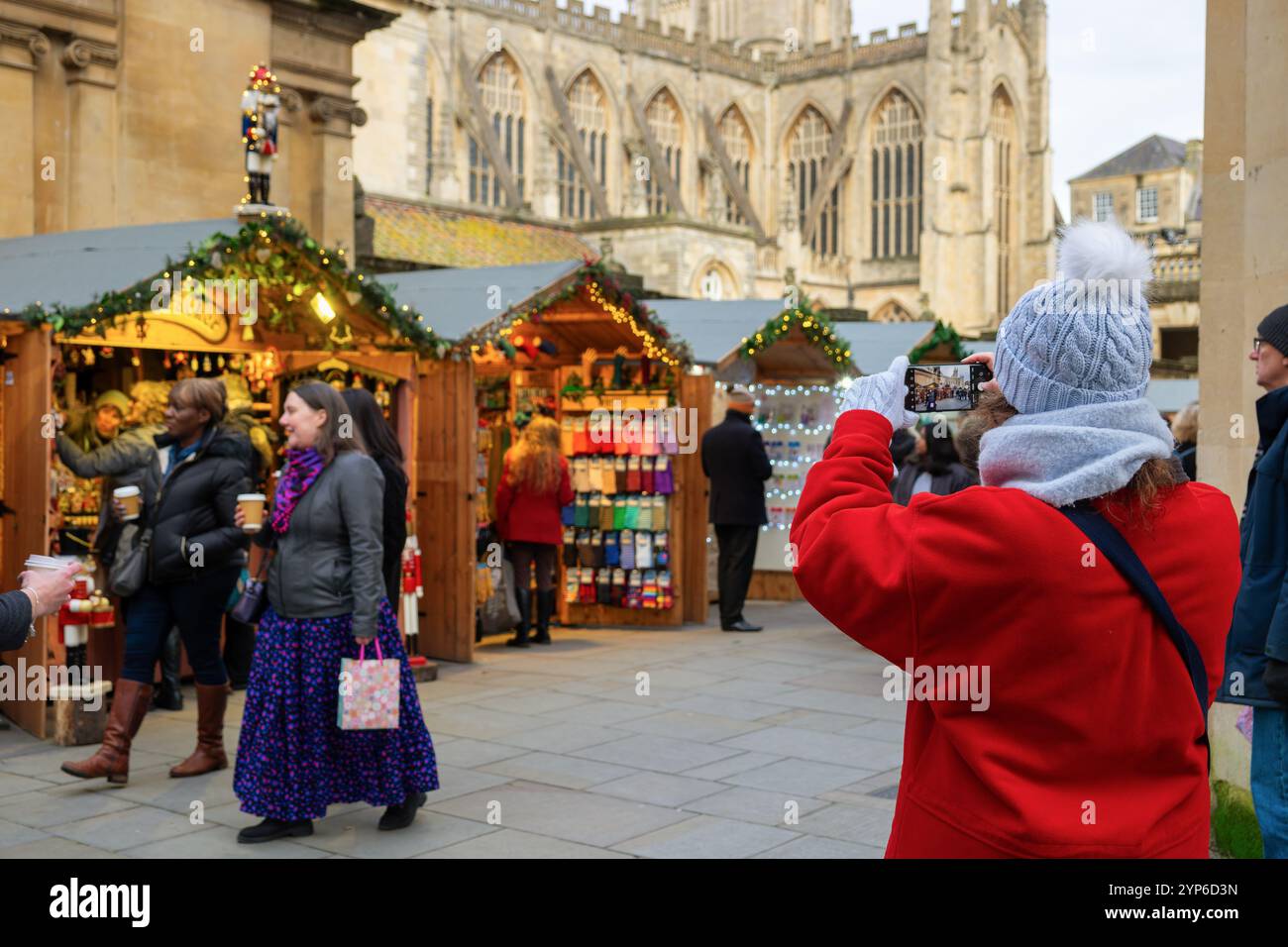 Bath, UK, 28th November 2024. A woman is pictured as she takes a photograph of some of the ...