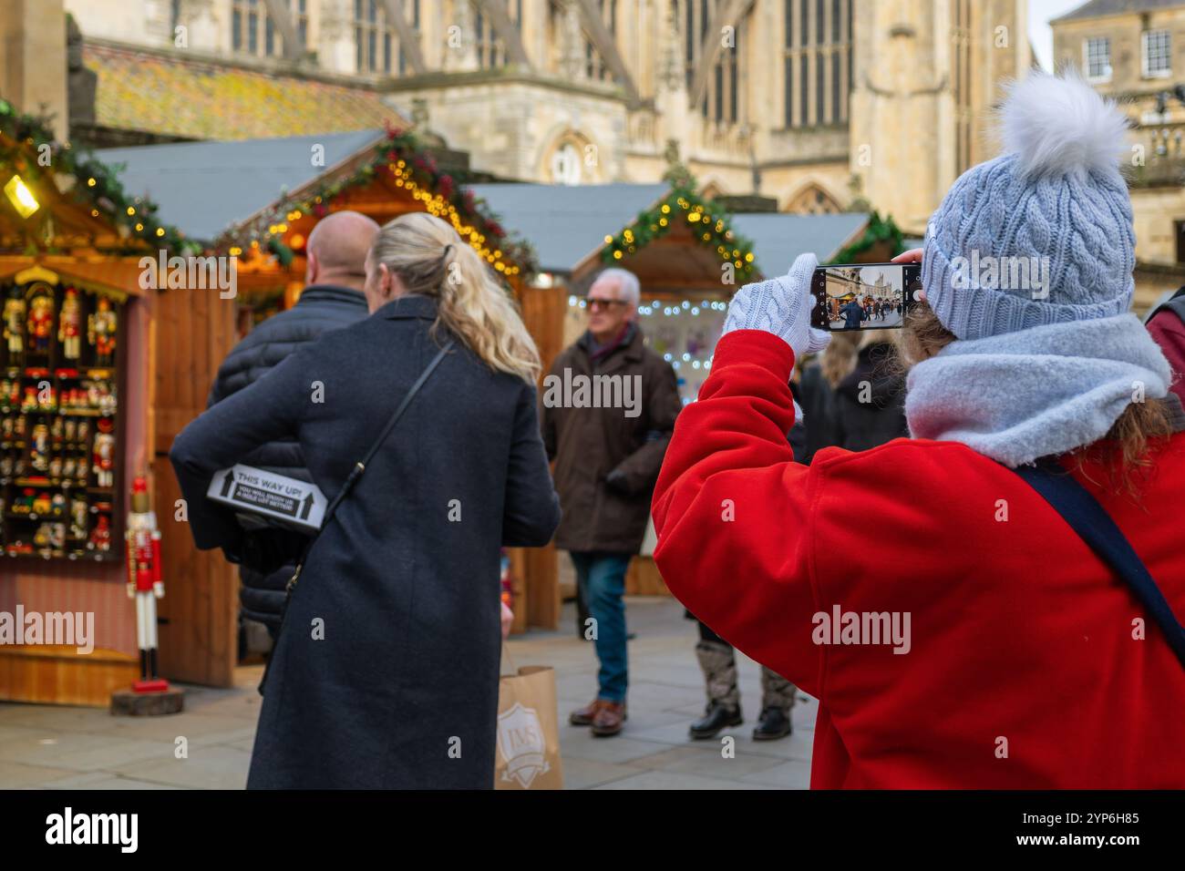 Bath, UK, 28th November 2024. A woman is pictured as she takes a photograph of some of the ...