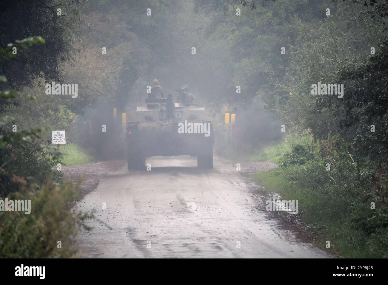 commander and gunner direct a Challenger 2 II FV4043 tank in pouring ...