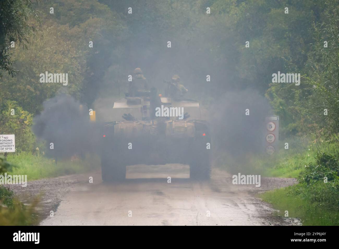 commander and gunner direct a Challenger 2 II FV4043 tank in pouring ...