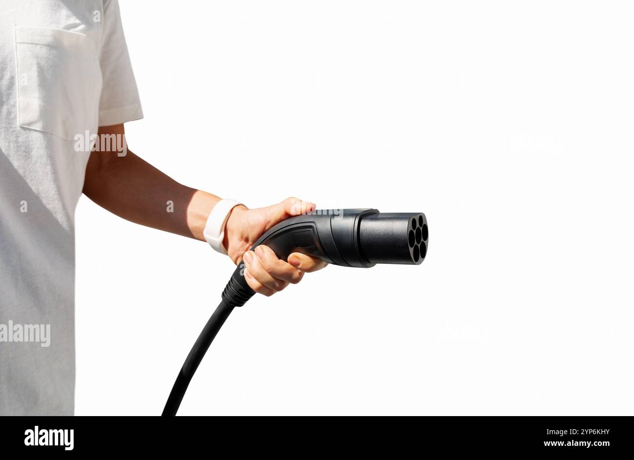 Isolated black EV charging plug in female hand. Electric car charging ...