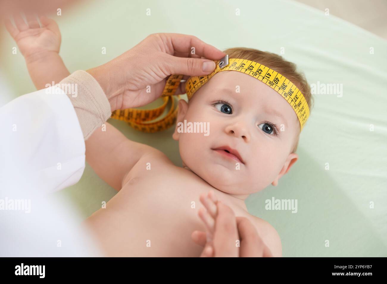 Pediatrician measuring little baby's head in clinic, closeup Stock ...
