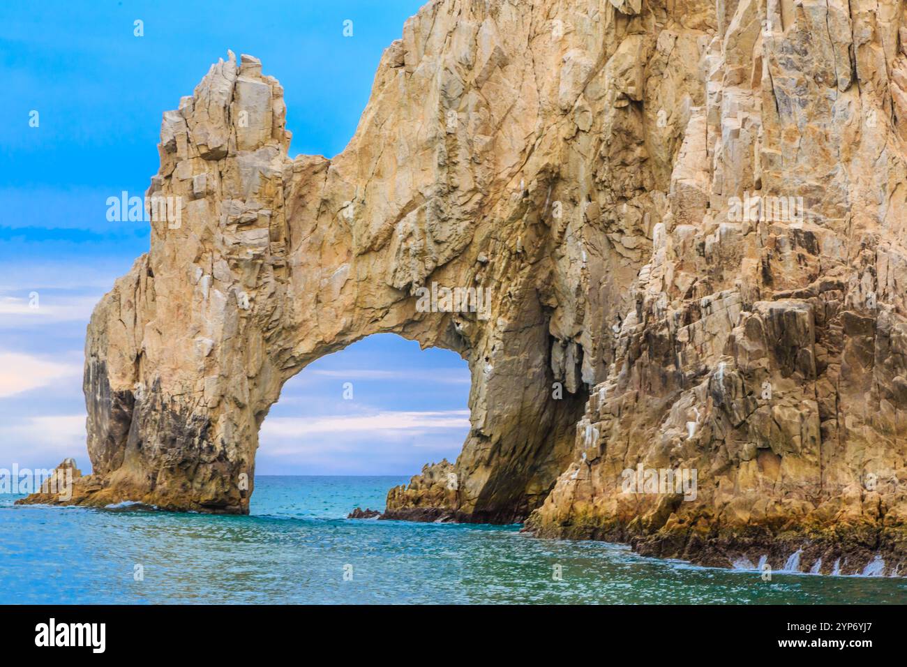A large rock formation with a large archway in the middle. The archway ...