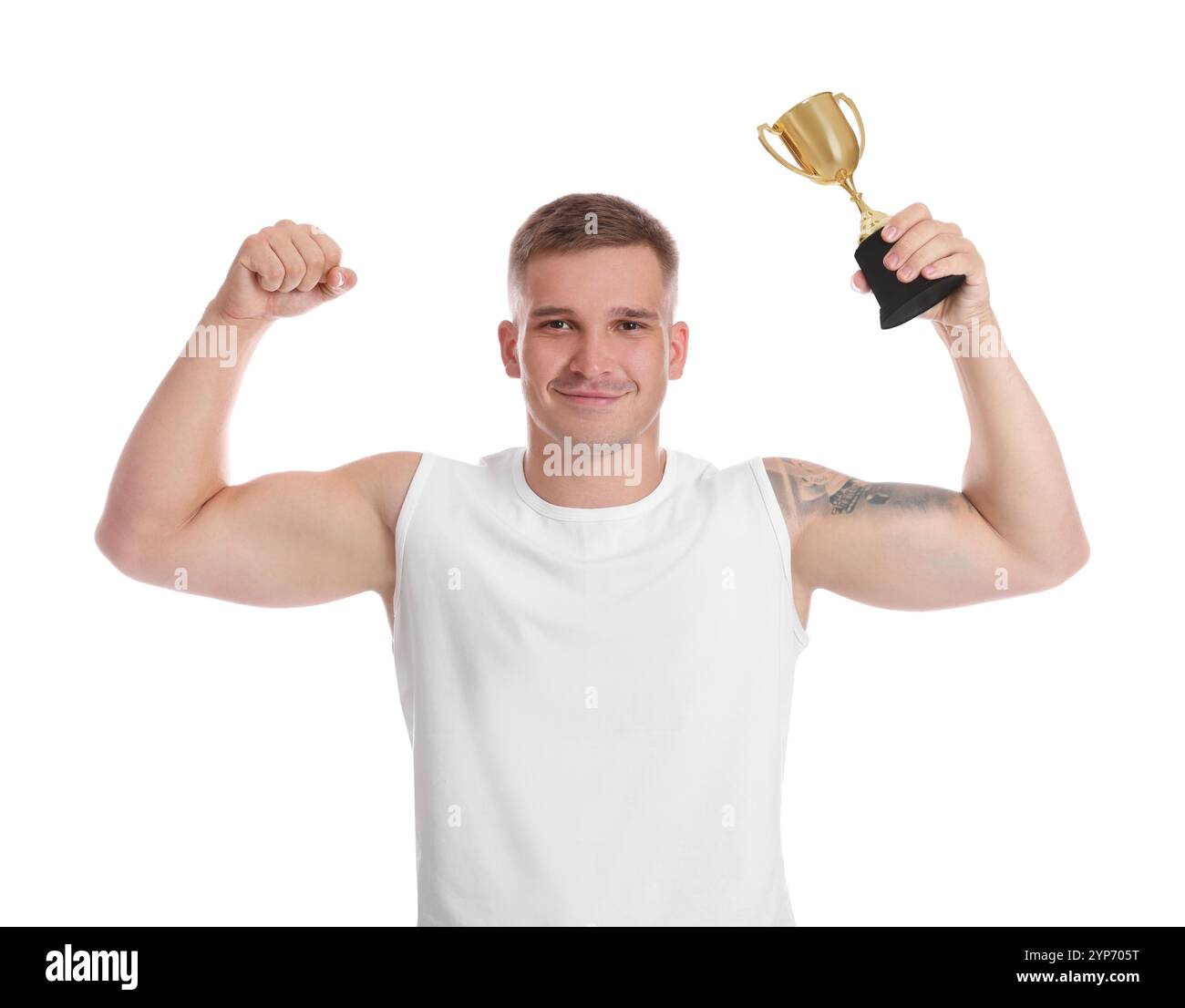 Smiling winner with golden trophy cup showing his biceps on white ...