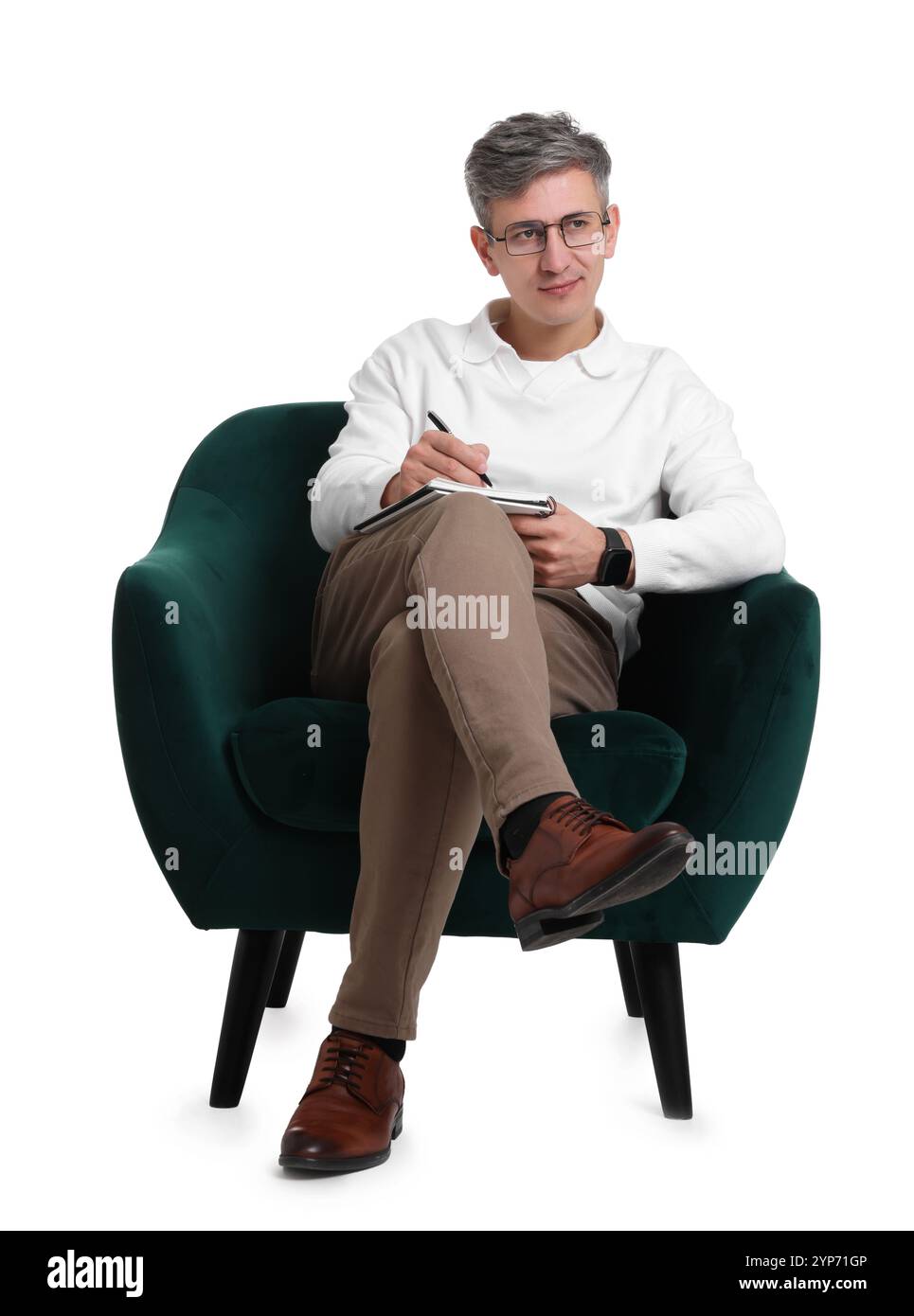 Professional psychologist with notebook sitting on chair against white ...