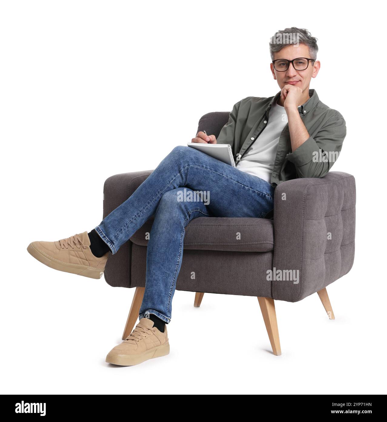 Professional psychologist with notebook sitting on chair against white ...