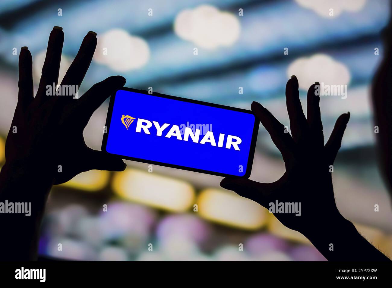 In this photo illustration, the Ryanair logo is displayed on a ...