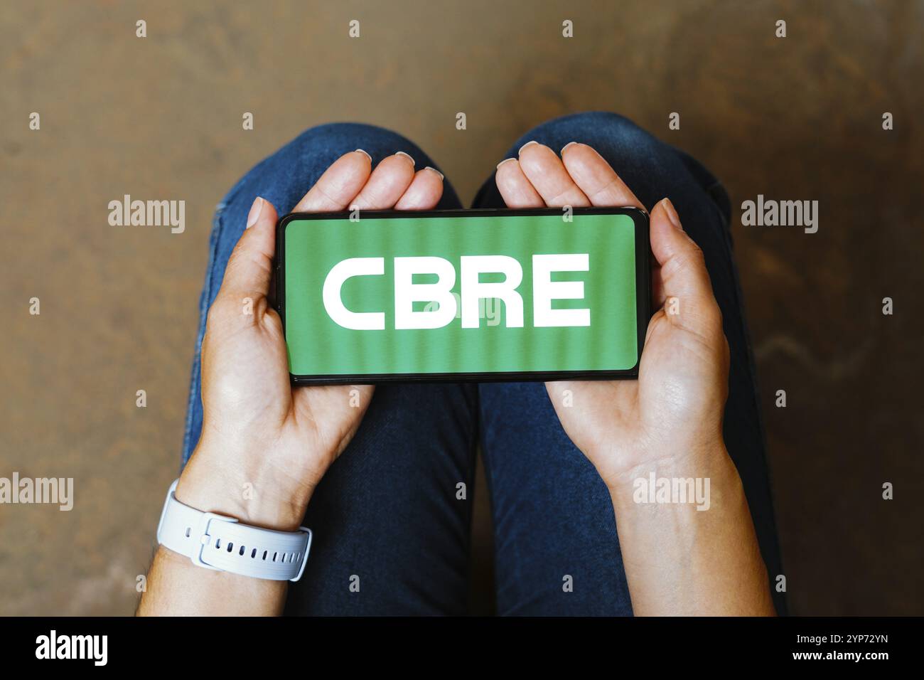 In this photo illustration, the CBRE Group logo is displayed on a ...