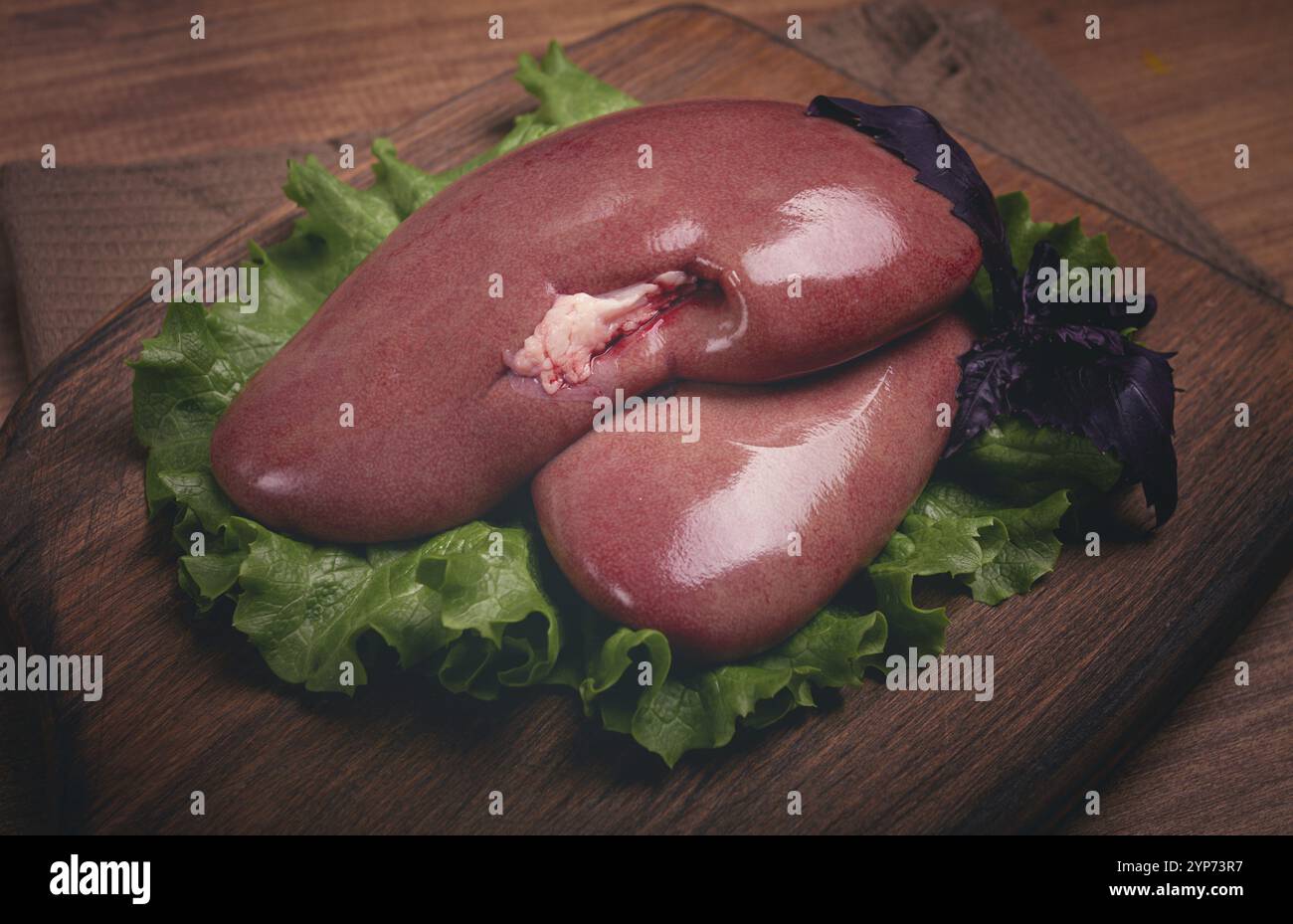 Raw pork kidneys, on a chopping board, close-up, top view, no people ...