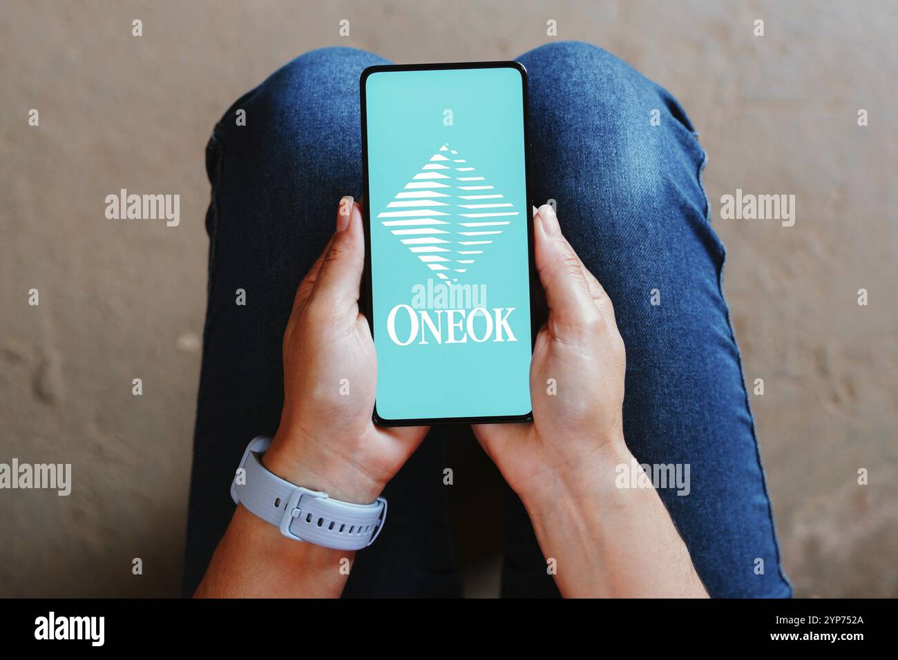 In this photo illustration, the Oneok logo is displayed on a smartphone ...