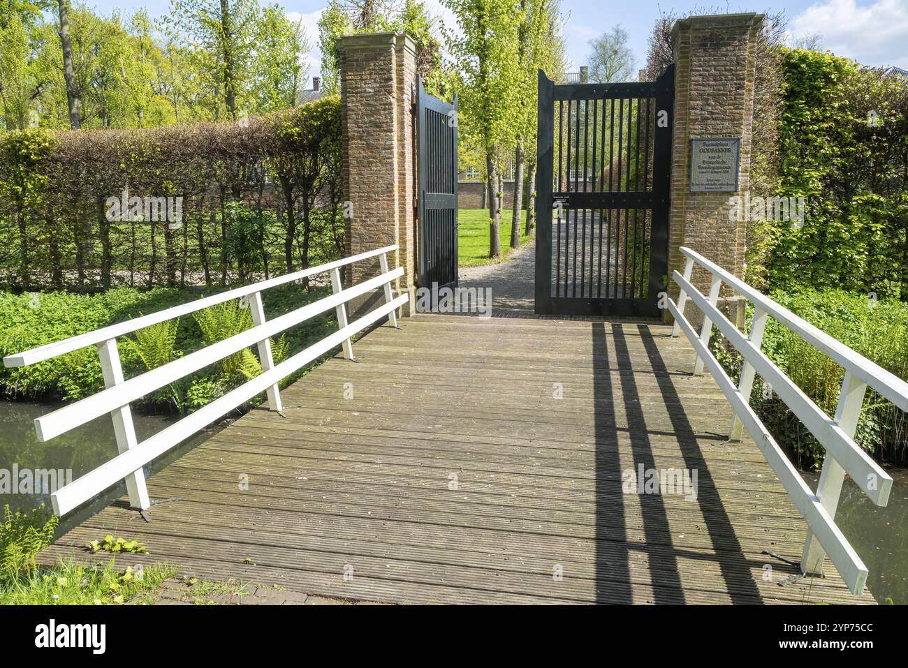 Wide pedestrian bridge over canal Stock Photo - Alamy