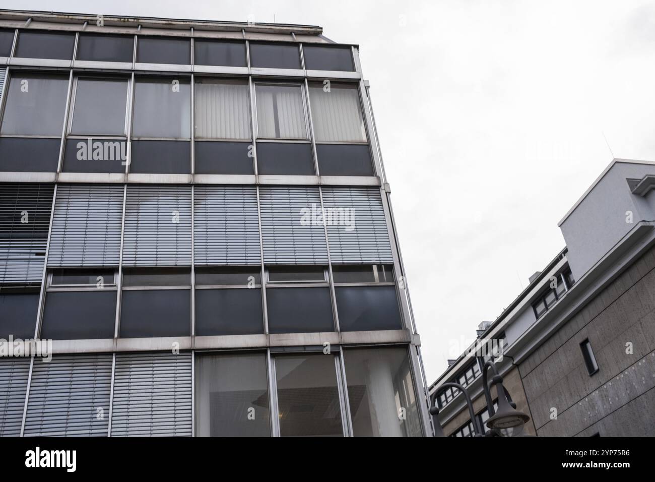 Modern building facade with glass windows and metal structure under an ...