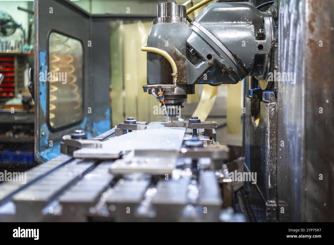 Milling machine molding shapes in metal pieces in a cnc factory with no ...