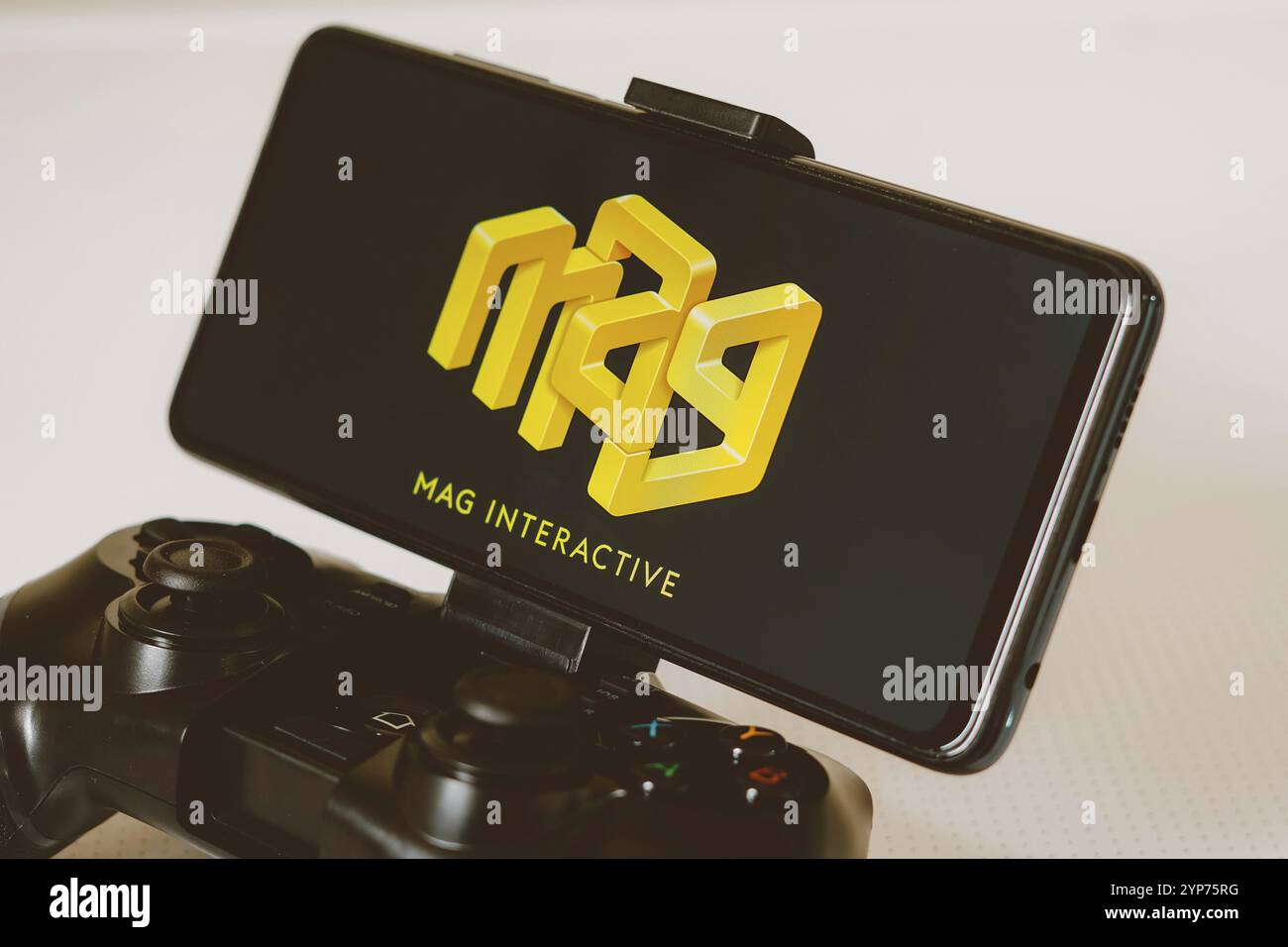 In this photo illustration, the MAG Interactive logo displayed on a smartphone screen, connected ...