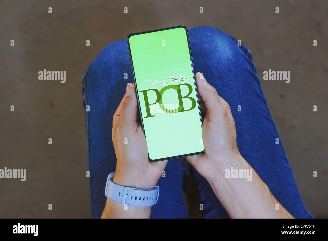 In this photo illustration, the Pendleton Community Bank (PCB) logo is ...