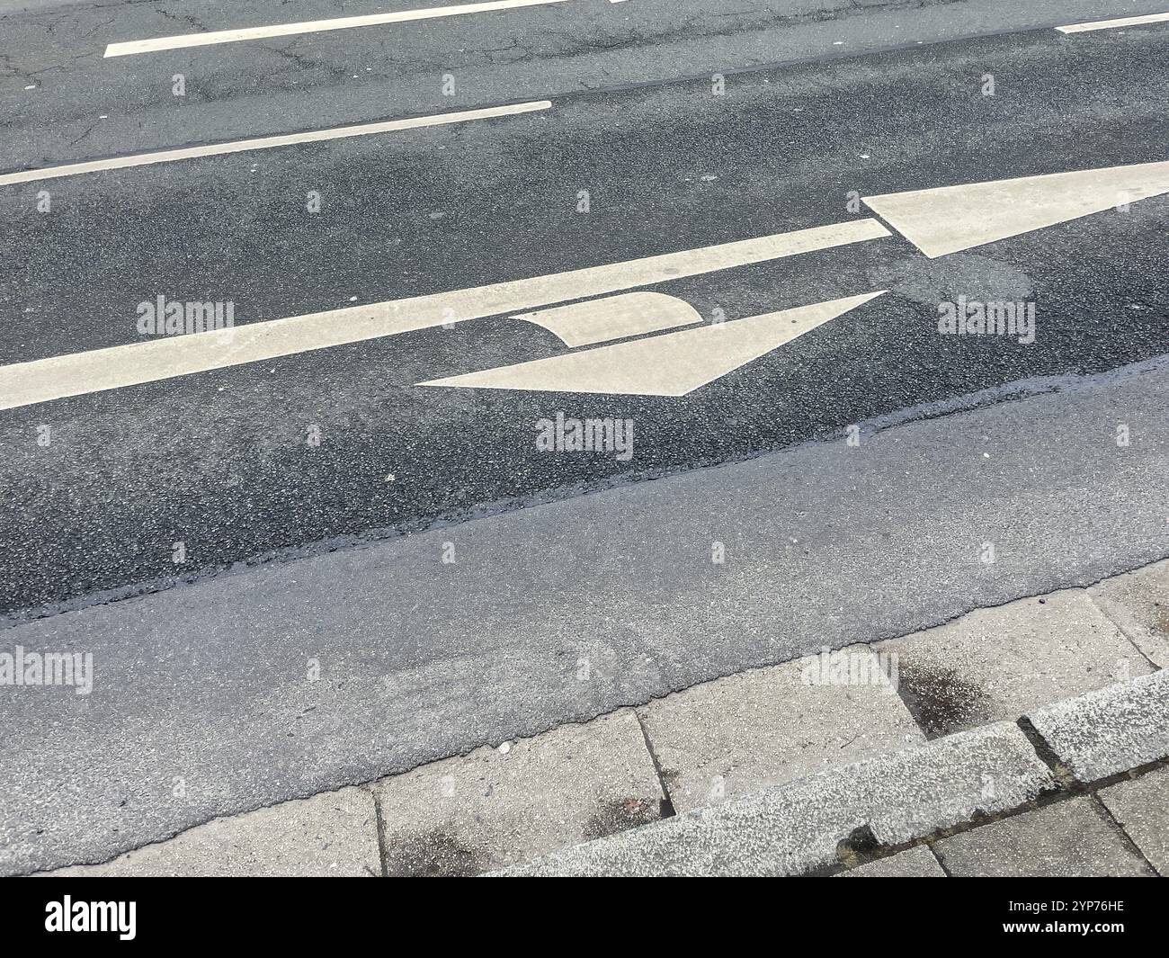 White directional arrows on a road Stock Photo - Alamy