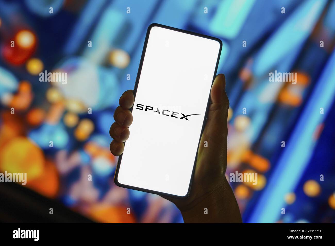 In this photo illustration, the SpaceX logo is displayed on a ...