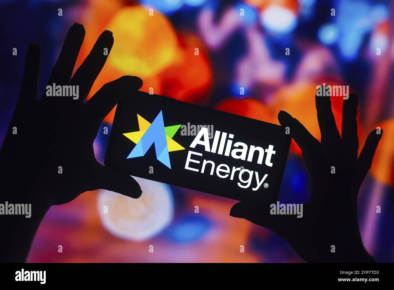 In this photo illustration, the Alliant Energy logo is displayed on a ...