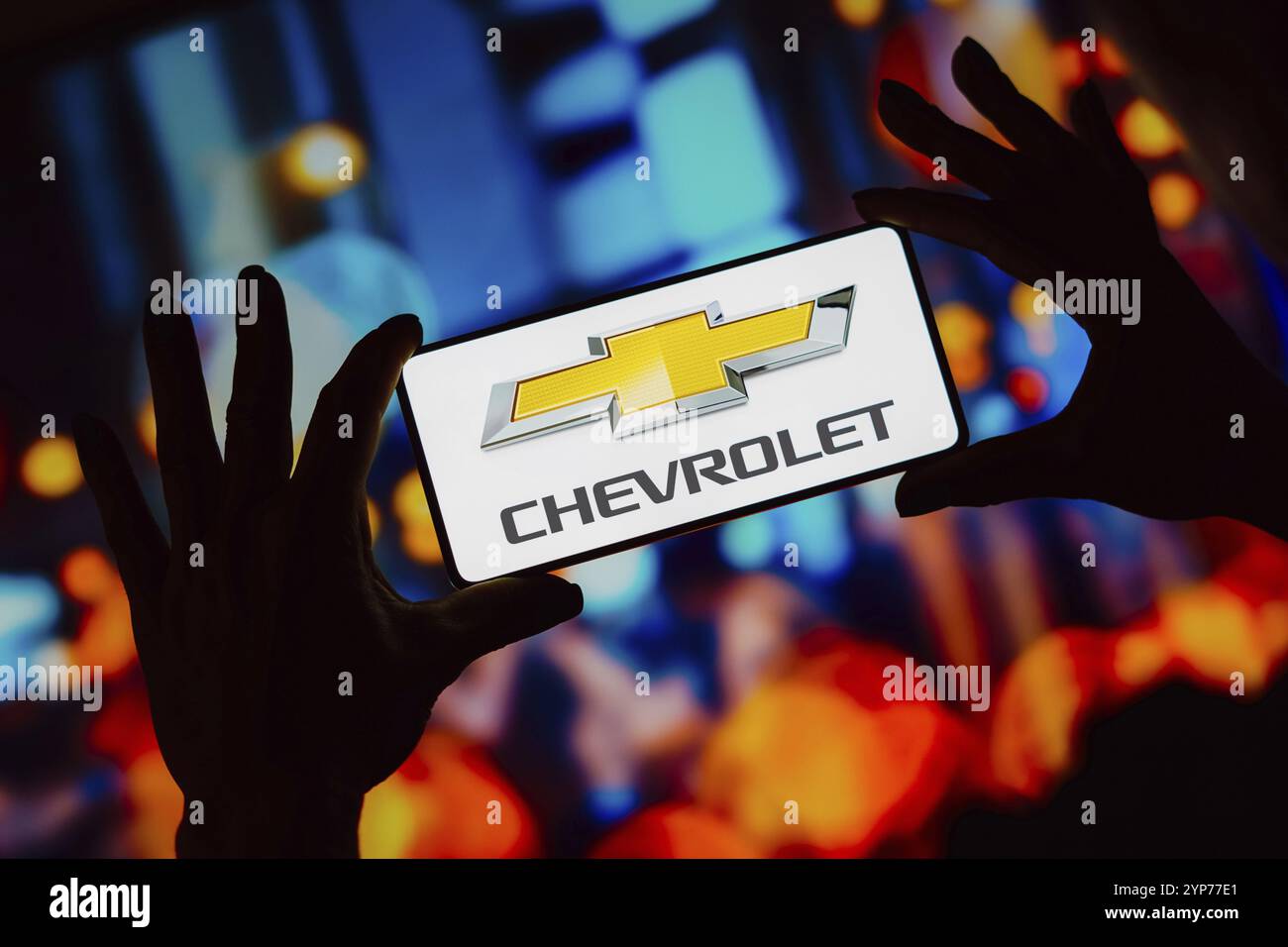 In this photo illustration, the Chevrolet logo is displayed on a ...