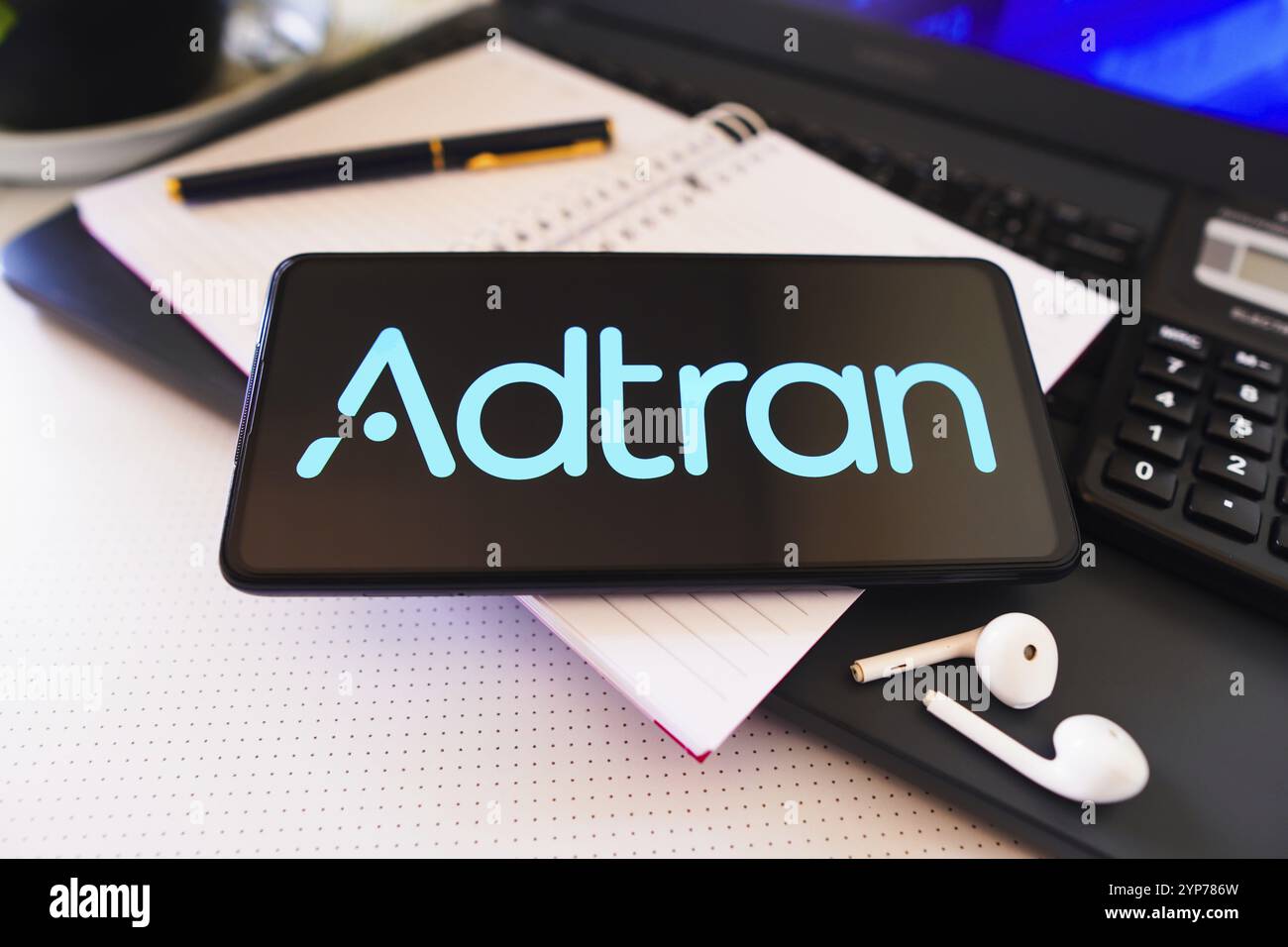 In this photo illustration, the Adtran logo is displayed on a smartphone screen Stock Photo - Alamy
