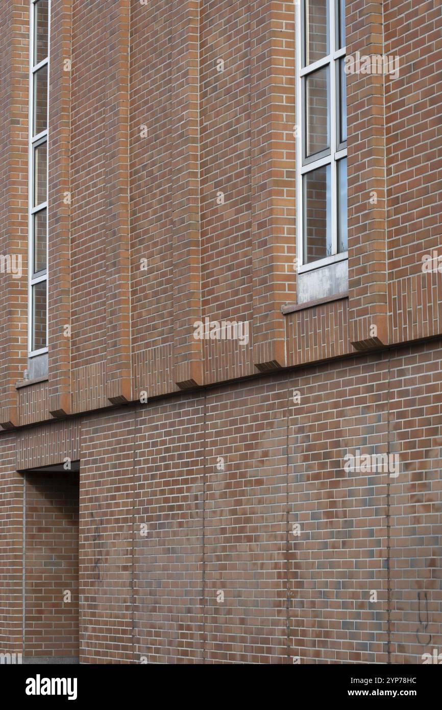 Brick wall with window and door of a large building Stock Photo - Alamy