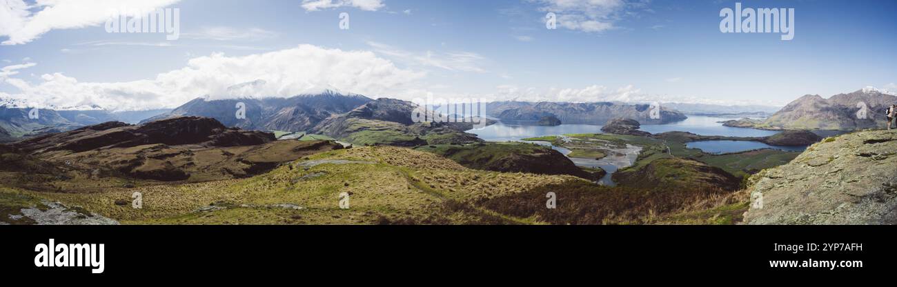 Wide panoramic view with mountains and lakes under a blue sky with ...
