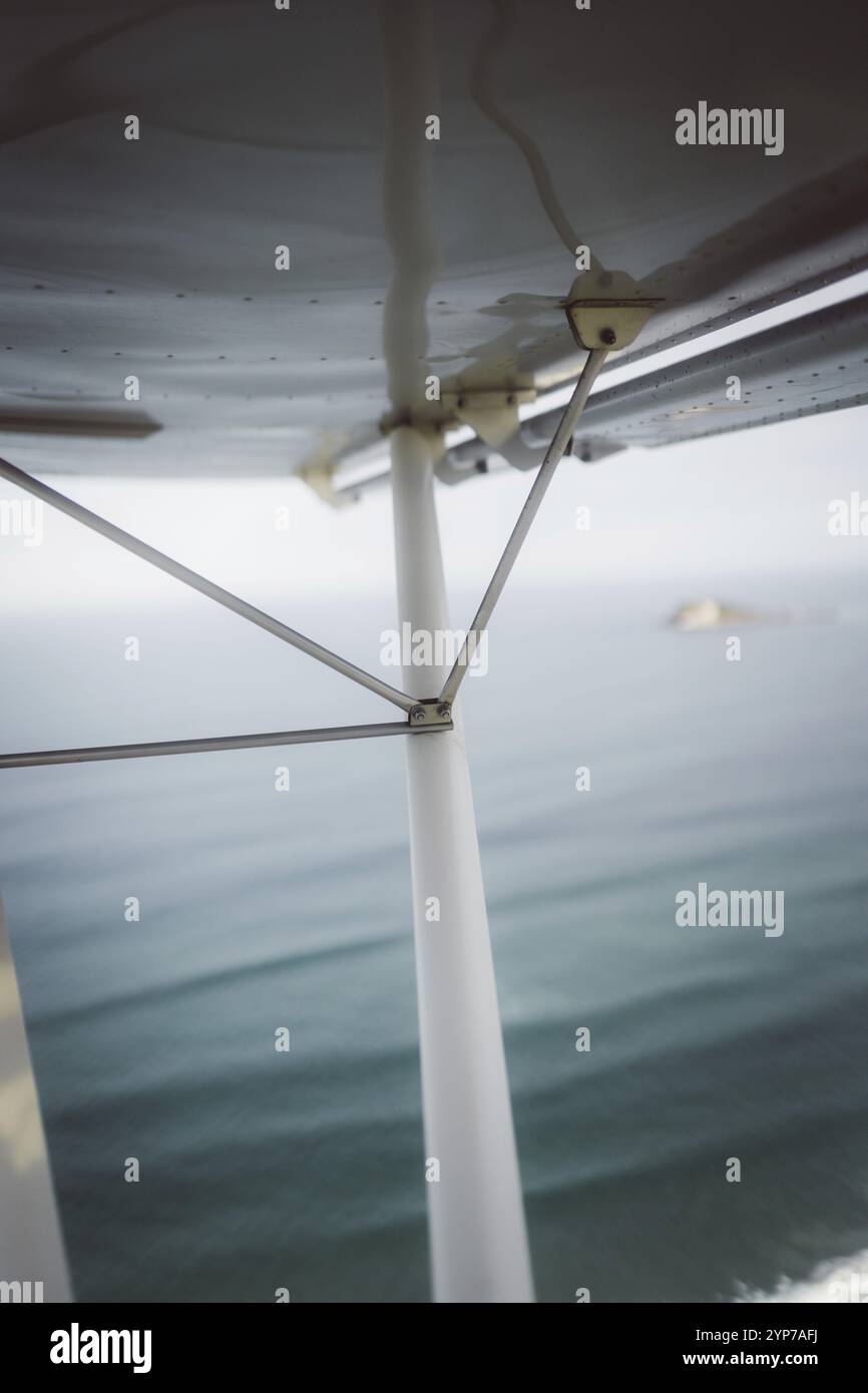 Wing of aeroplane over ocean island hi-res stock photography and images ...