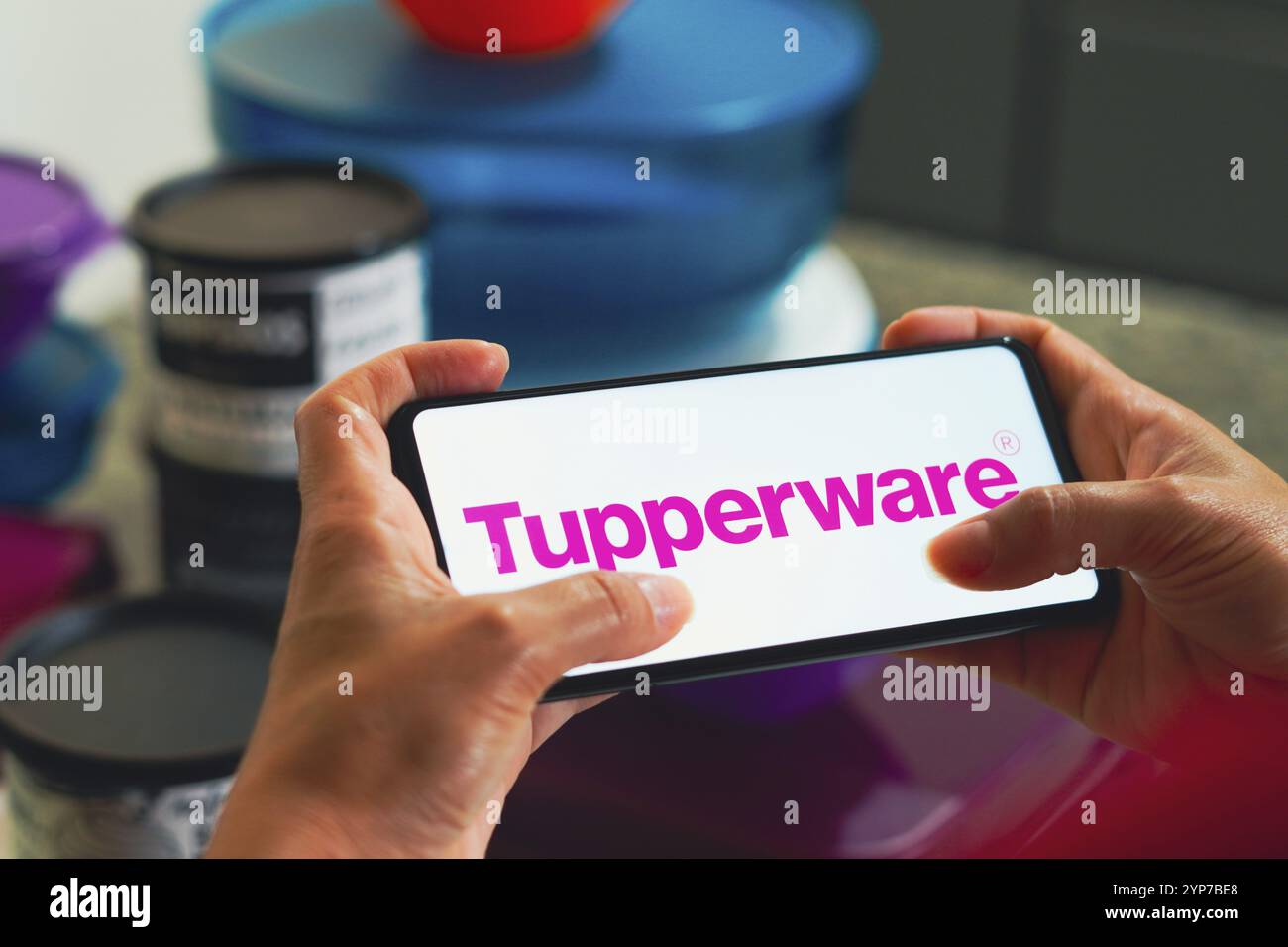 In this photo illustration, the Tupperware logo is displayed on a ...