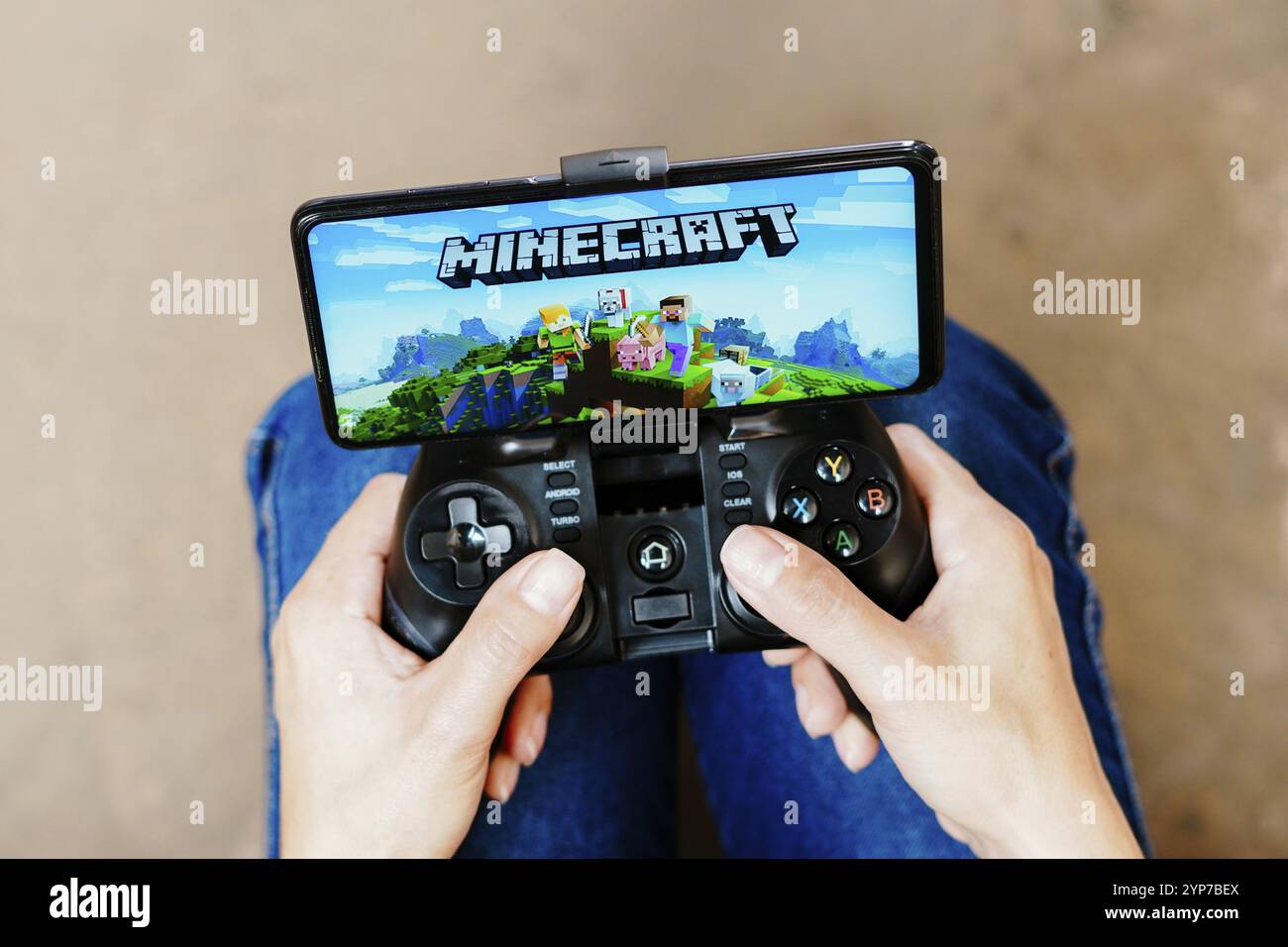 In this photo illustration, a person playing on a joystick and the ...