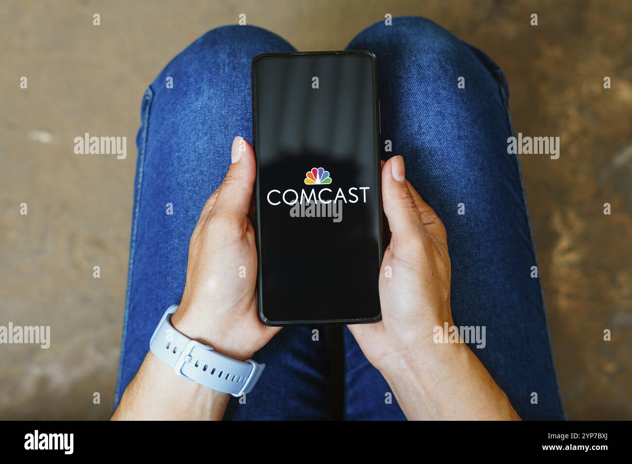 In this photo illustration, the Comcast Corporation logo is displayed ...