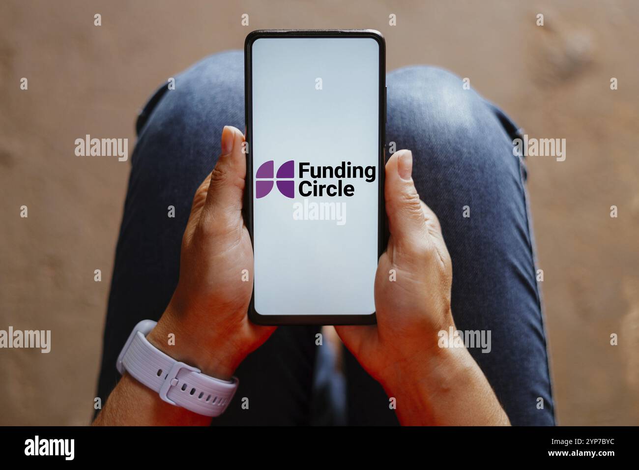 In this photo illustration, the Funding Circle logo is displayed on a smartphone screen Stock ...