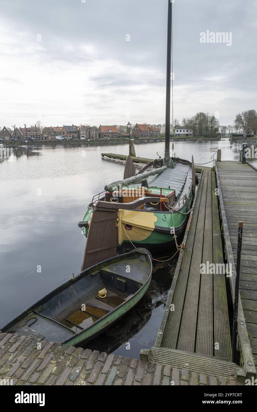 Hellish flat-bottomed ship at the jetty Stock Photo - Alamy