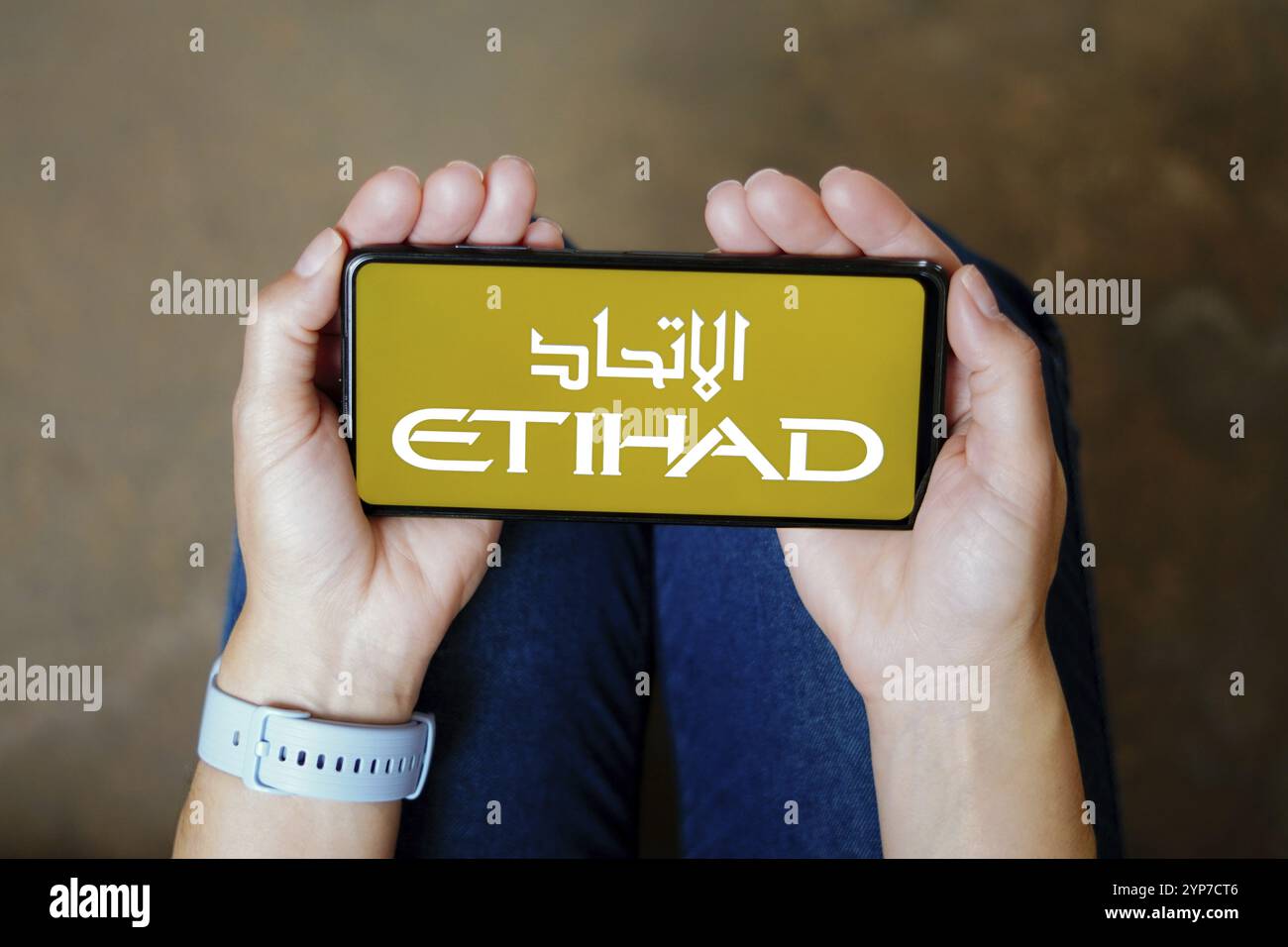 In this photo illustration, the Etihad Airways logo seen displayed on a ...