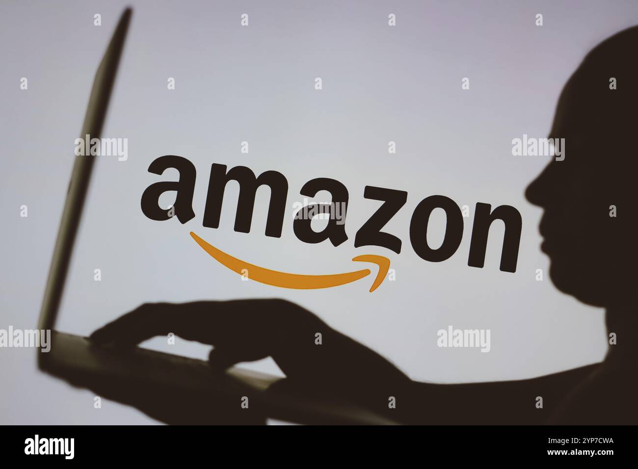 In this photo illustration, the Amazon logo is seen in the background ...