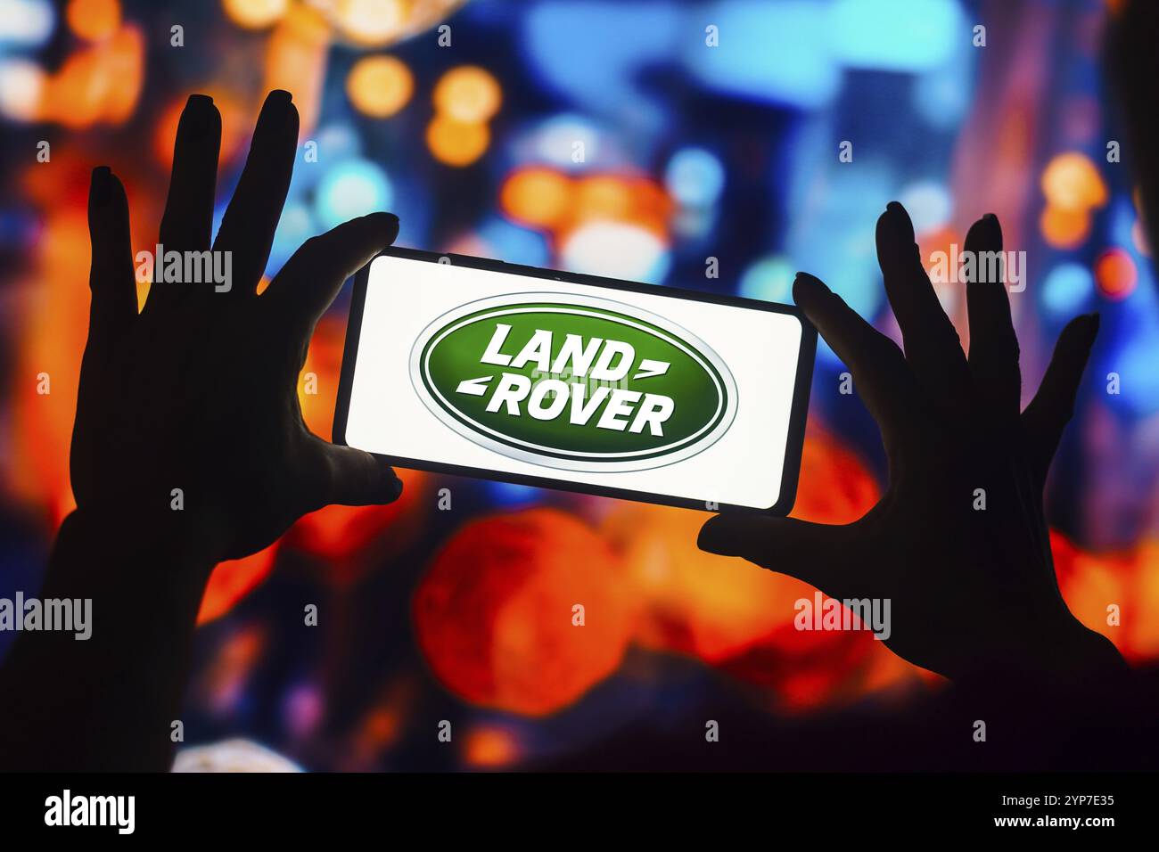 In this photo illustration, the Land Rover logo is displayed on a ...