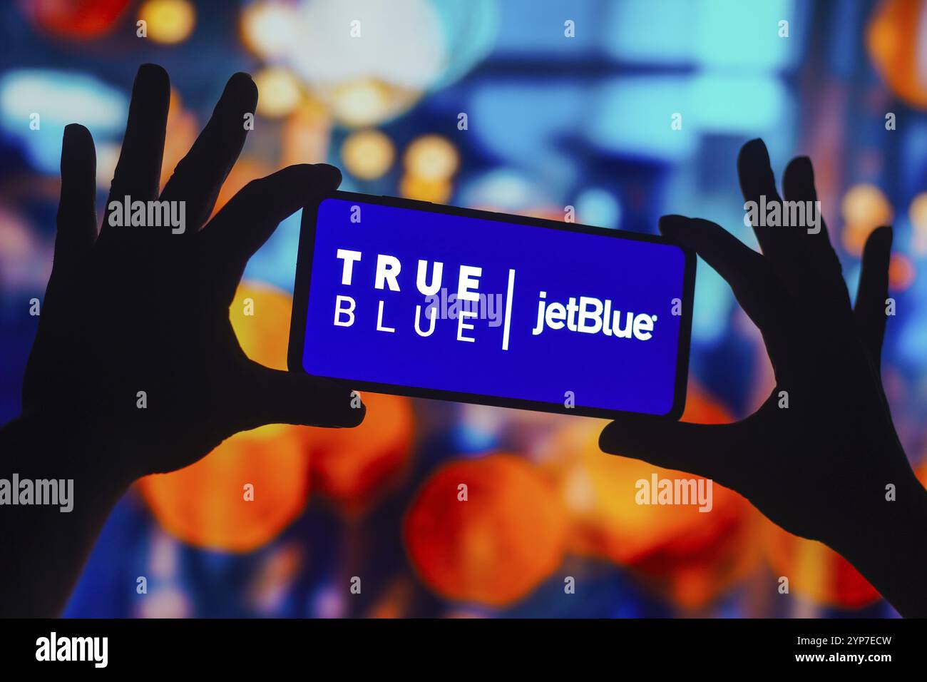 In this photo illustration, the TrueBlue JetBlue logo is displayed on a ...