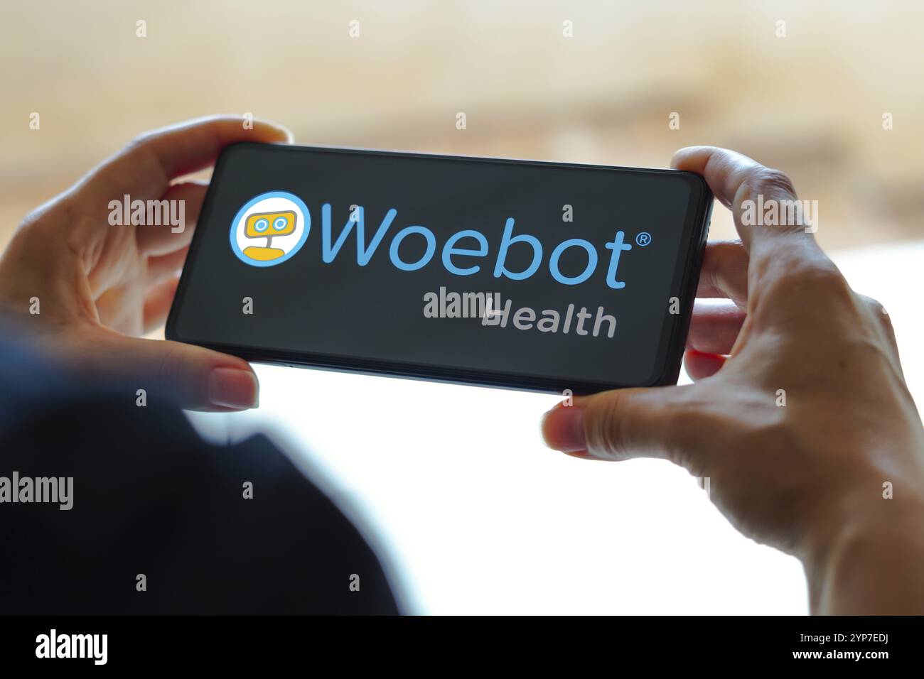 In this photo illustration the Woebot Health logo seen displayed on a ...