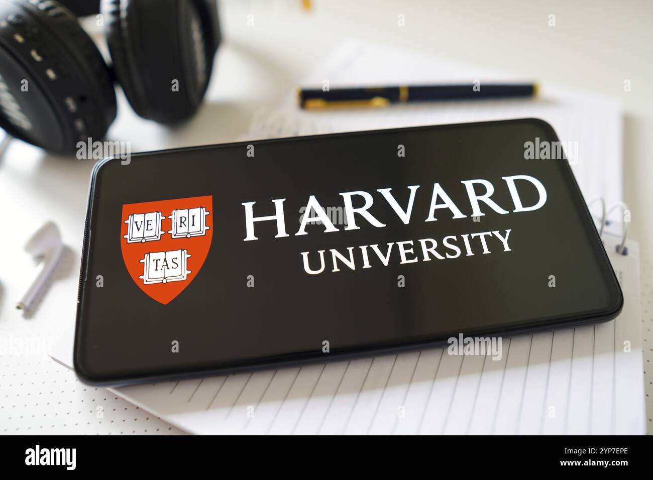 In this photo illustration, the Harvard University logo is displayed on ...