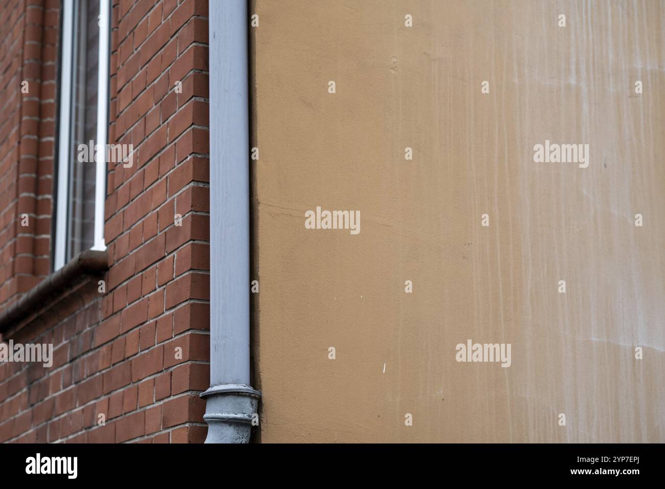 Colored house corner with rain pipe Stock Photo - Alamy