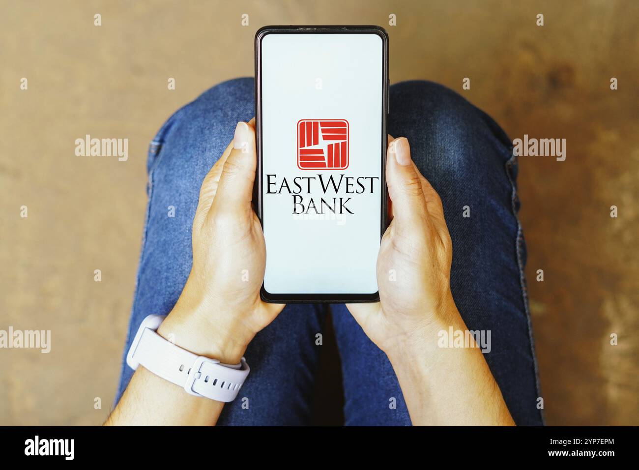 In this photo illustration, the East West Bank logo seen displayed on a smartphone Stock Photo ...