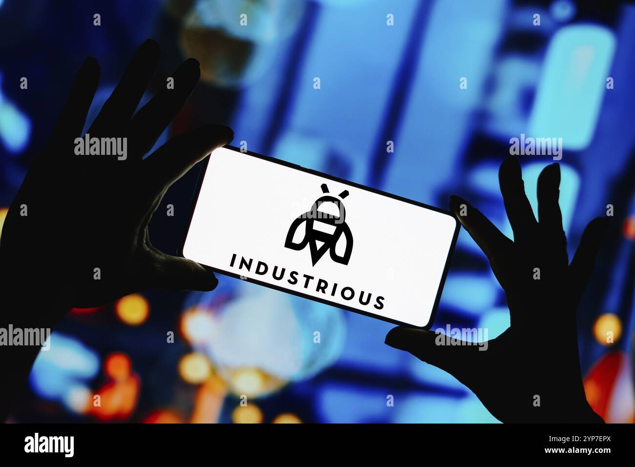 In this photo illustration, the Industrious logo is displayed on a ...
