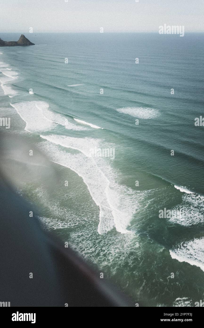 The ocean is shown from the air with gentle waves and clear blue water ...