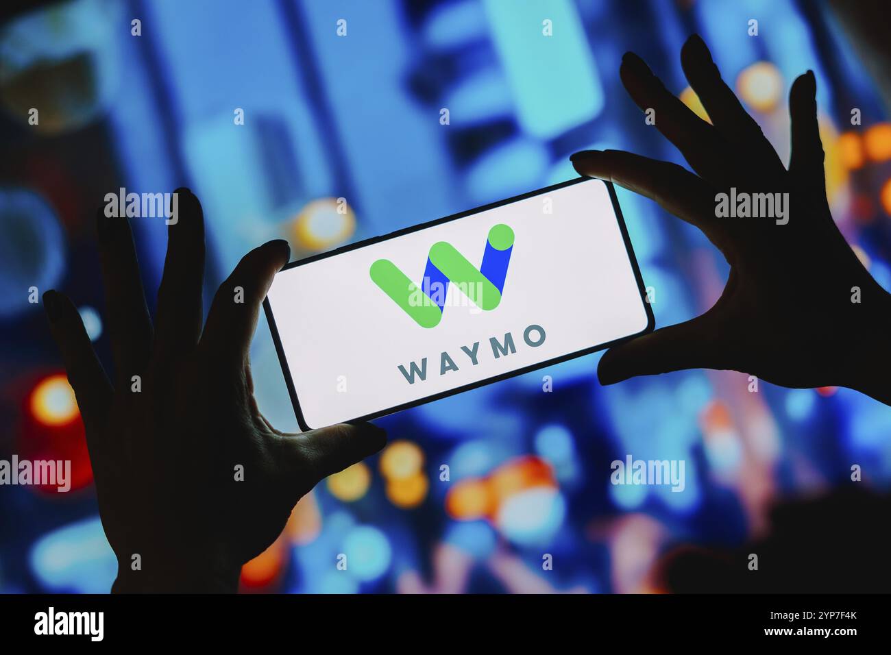 In this photo illustration, the Waymo logo is displayed on a smartphone ...