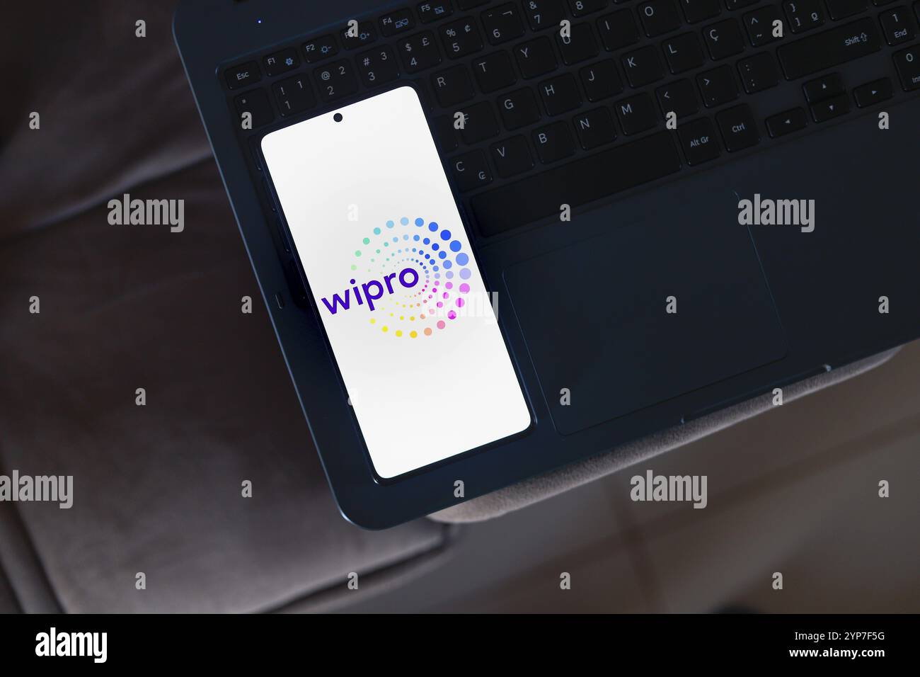 In this photo illustration, the Wipro Technologies logo is displayed on a smartphone screen ...