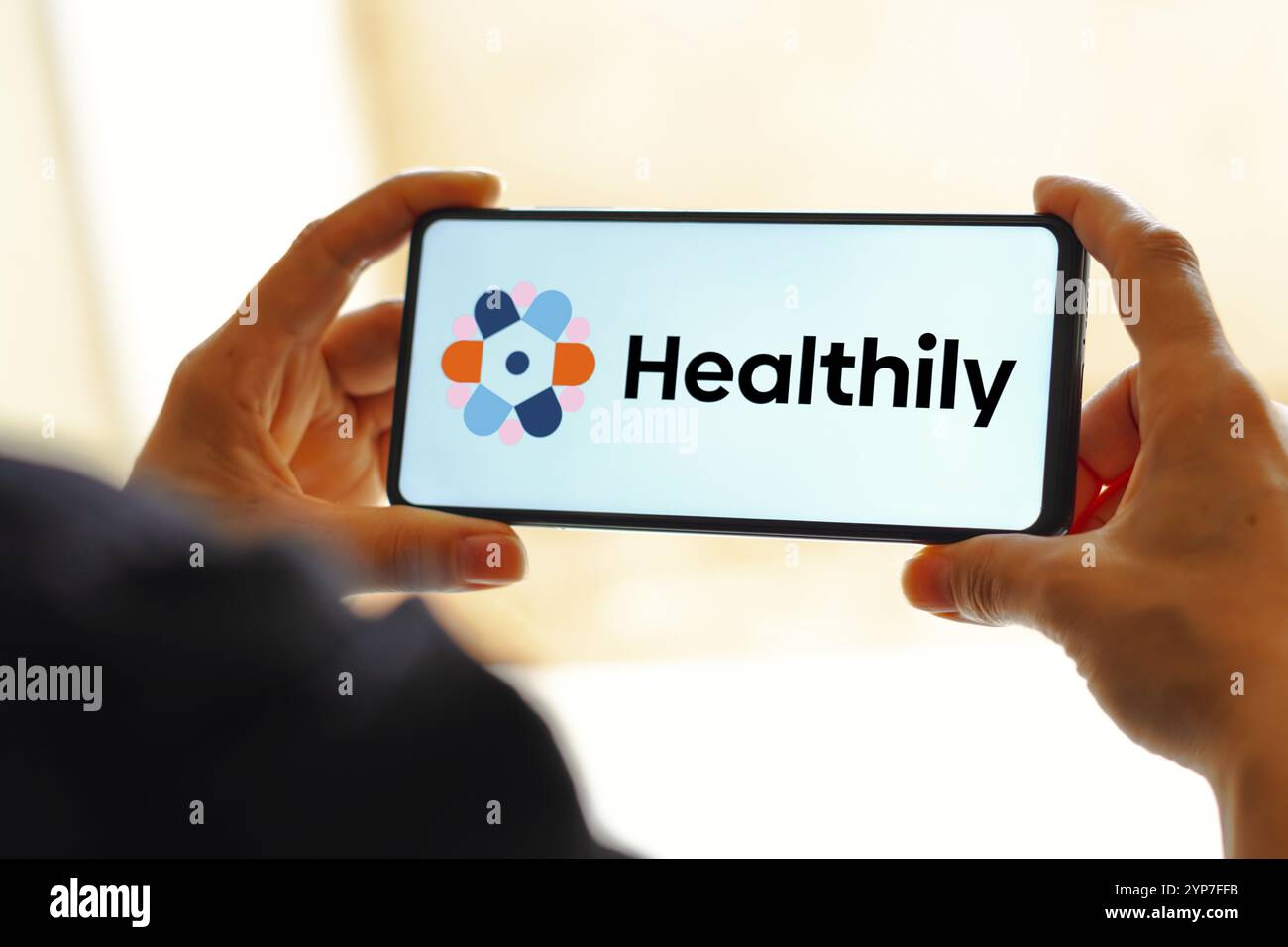 In this photo illustration the Healthily logo seen displayed on a ...