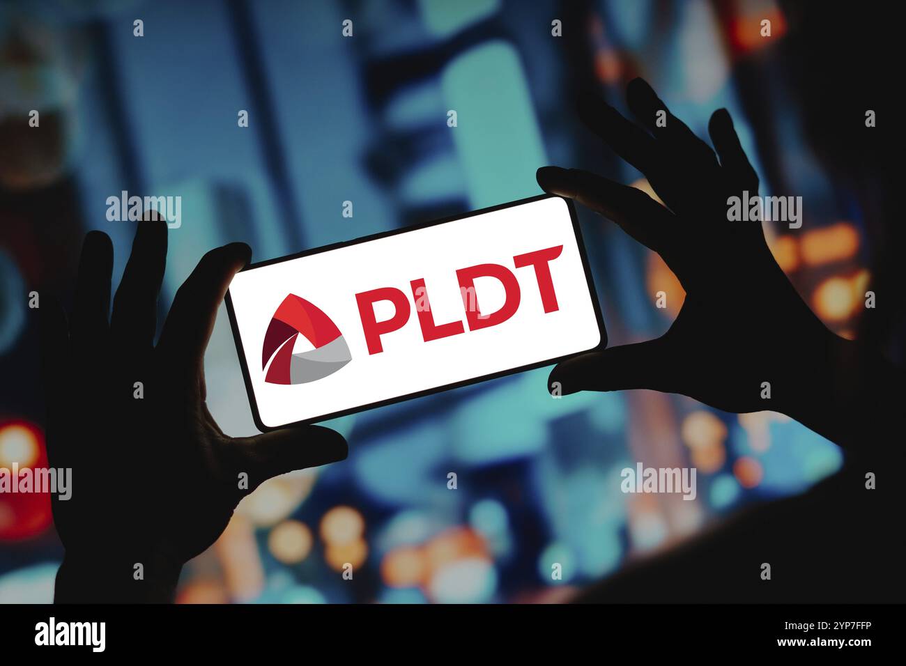 In this photo illustration, the PLDT logo is displayed on a smartphone screen Stock Photo - Alamy