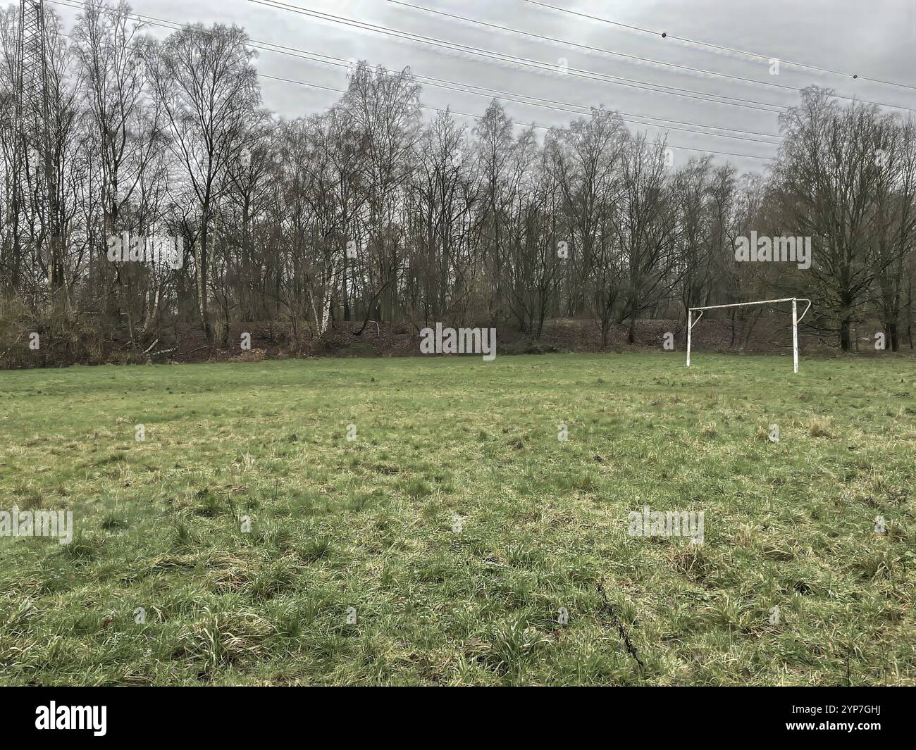 Poorly maintained soccer pitch with old soccer goal in the rain Stock ...