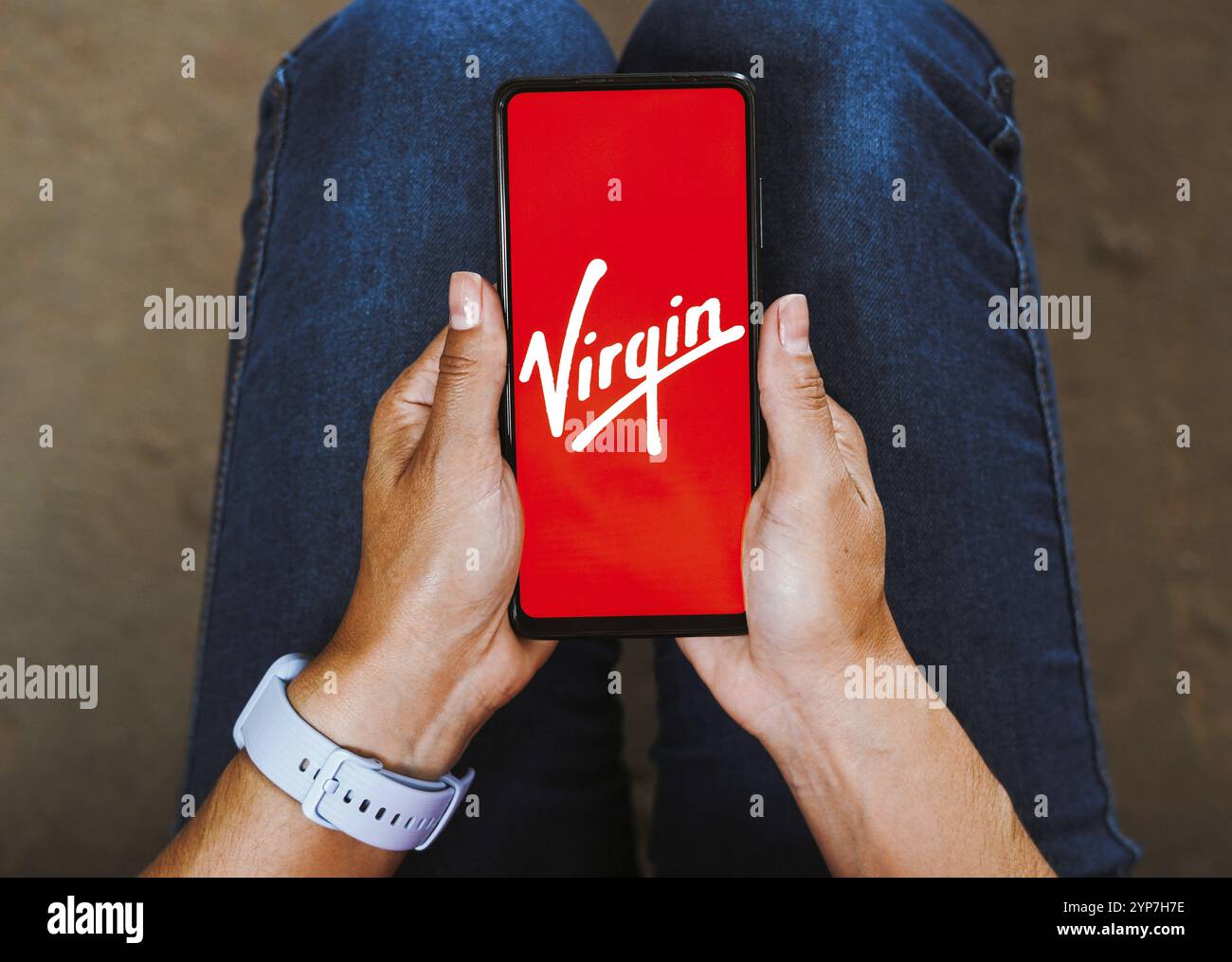 In this photo illustration, the Virgin Group logo is displayed on a smartphone screen Stock ...