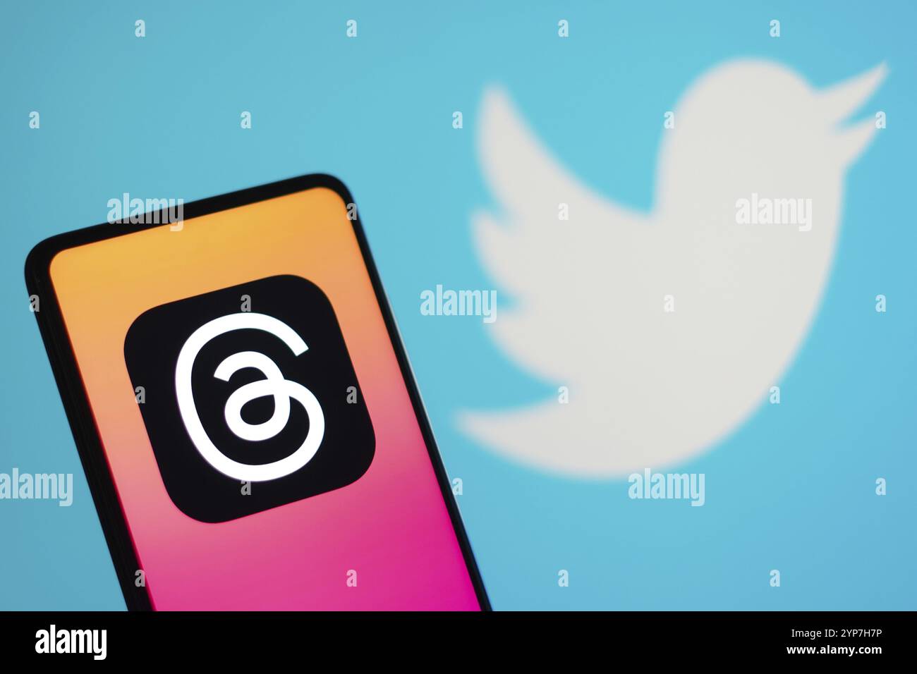 In the background, the Twitter logo Stock Photo - Alamy