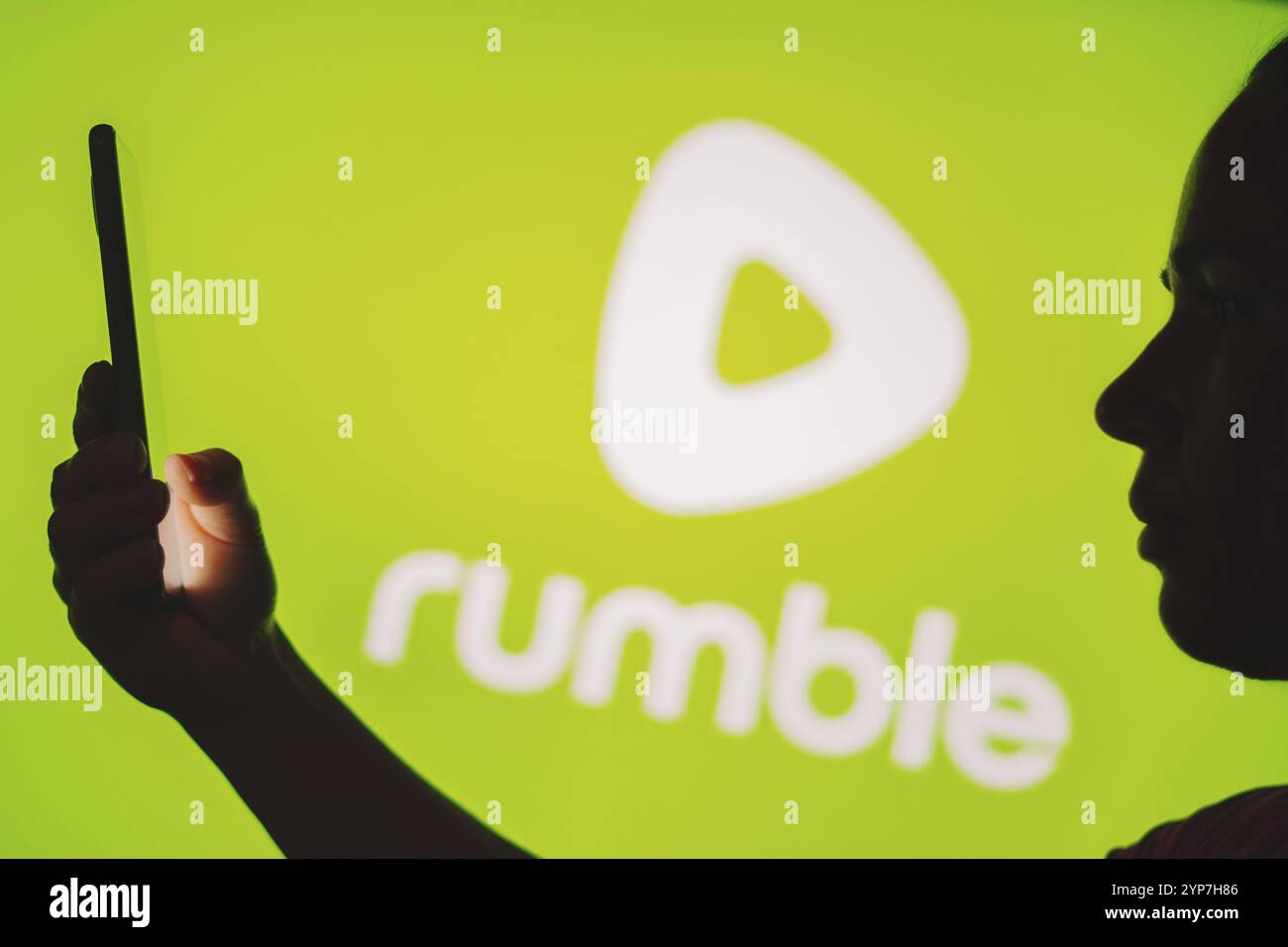 In this photo illustration, a woman's silhouette holds a smartphone ...